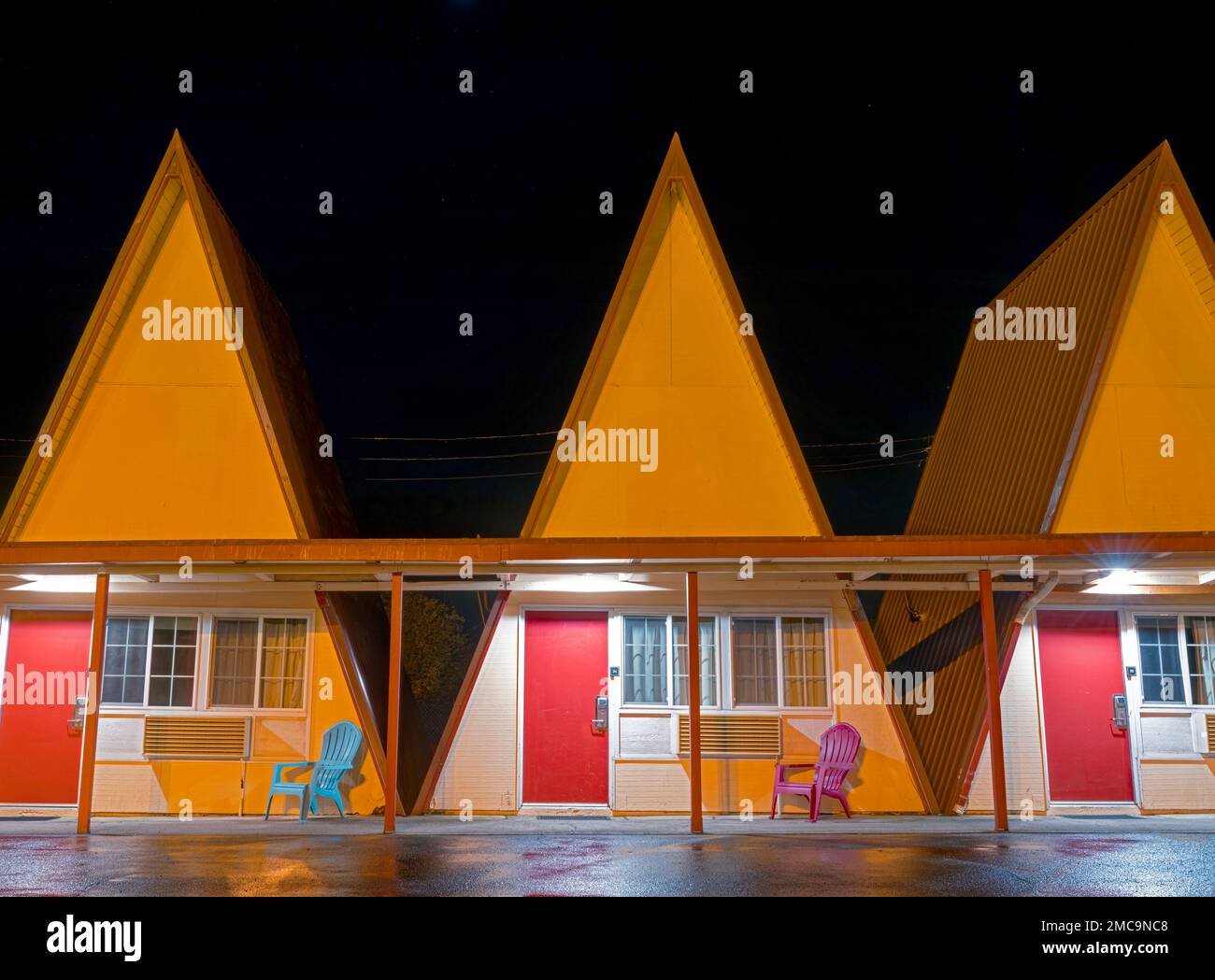 Three of the A-frame rooms of the Ranch Motel at night in Oakland ...
