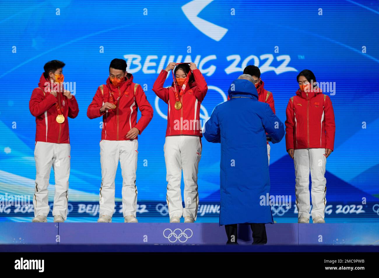 Team China, gold medalists, receive their medals for the mixed relay ...