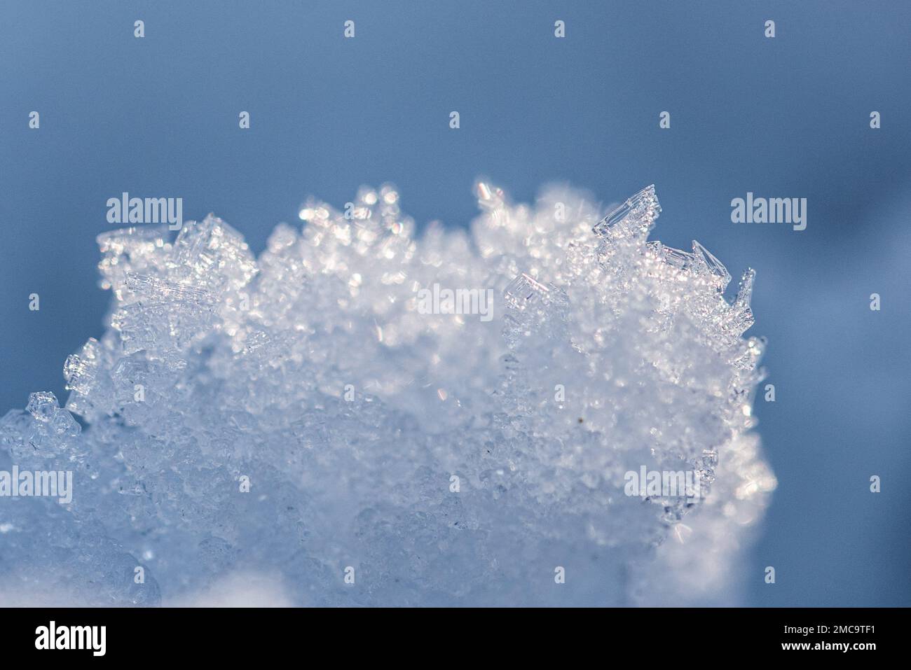 Snow as background, closeup view. Winter weather. Spring grainy blue ...