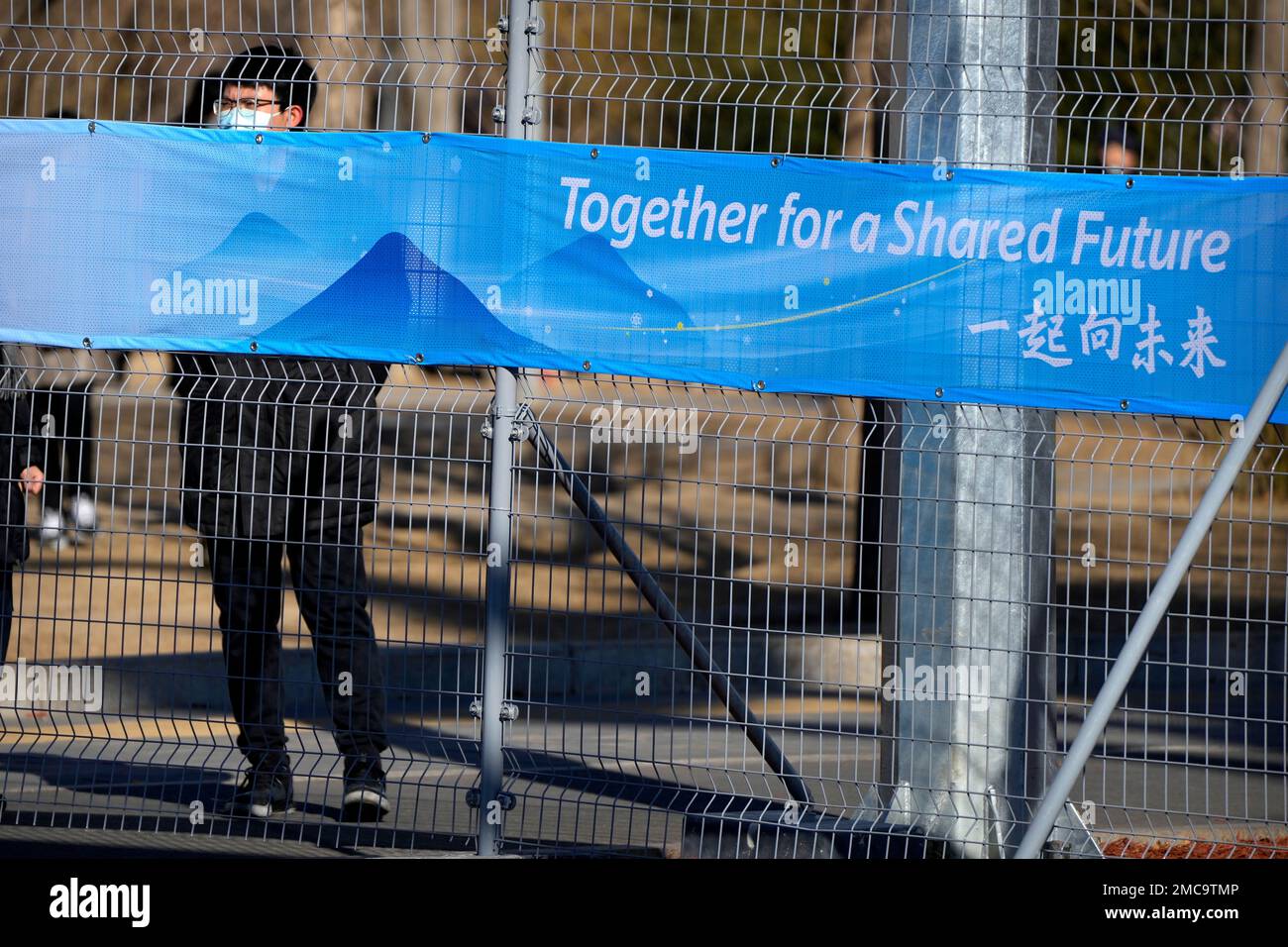 FILE - A person looks through the fence at the closed-loop area for ...
