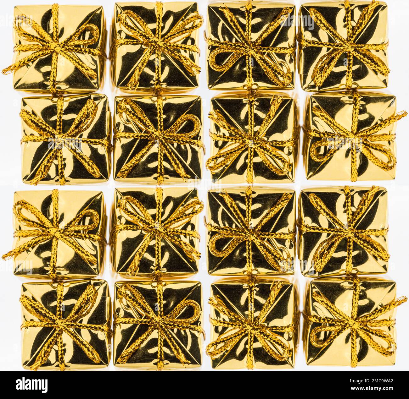 Gift boxes of gold color isolated on white background Stock Photo - Alamy