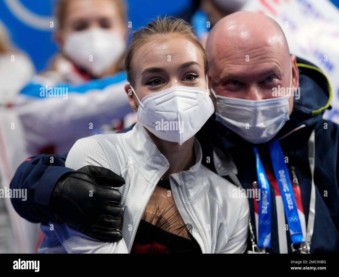 Anastasiia Gubanova, of Georgia, is embraced by her coach as she reacts ...
