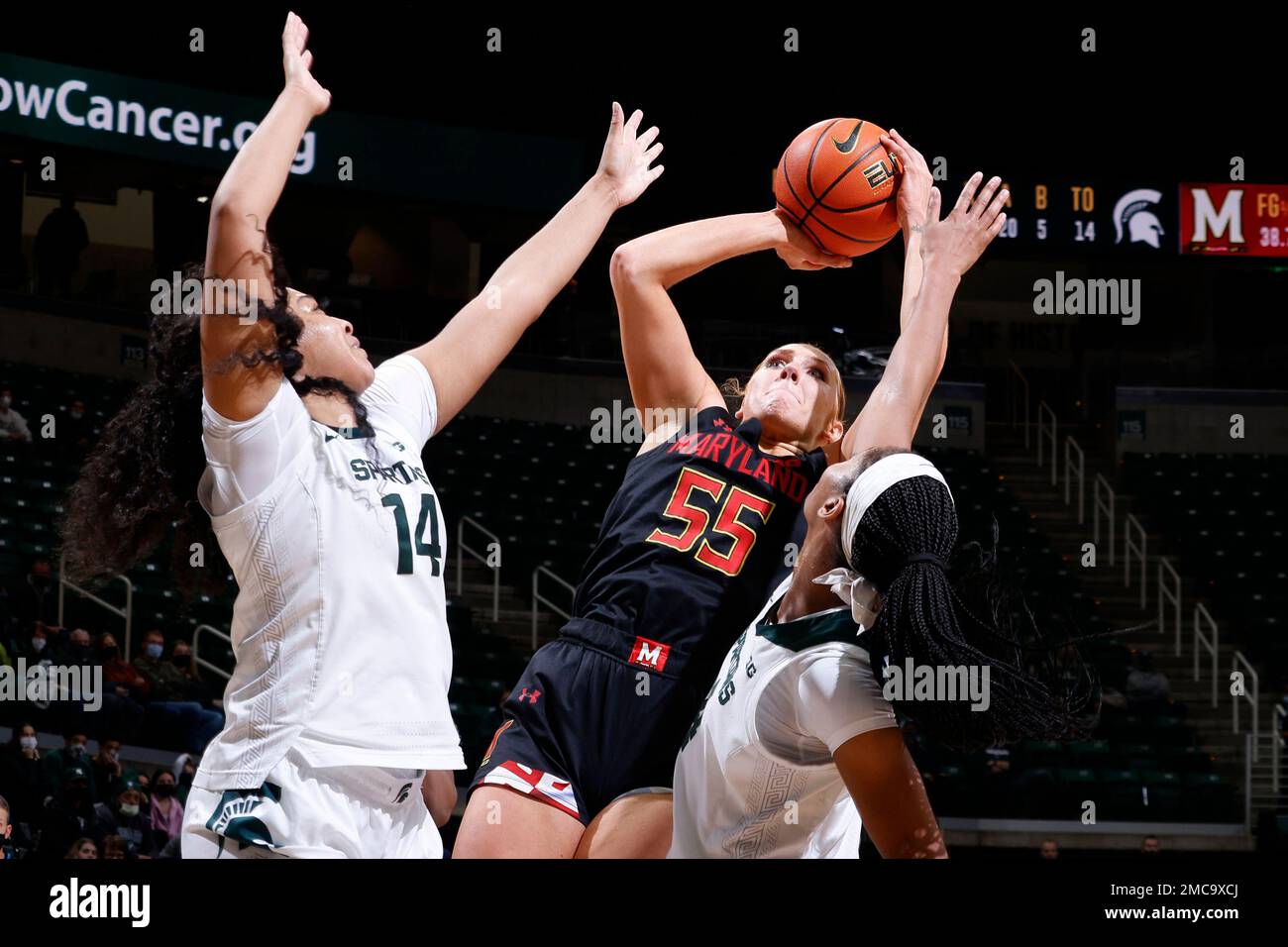 Maryland's Chloe Bibby (55) shoots between Michigan State's Taiyier ...