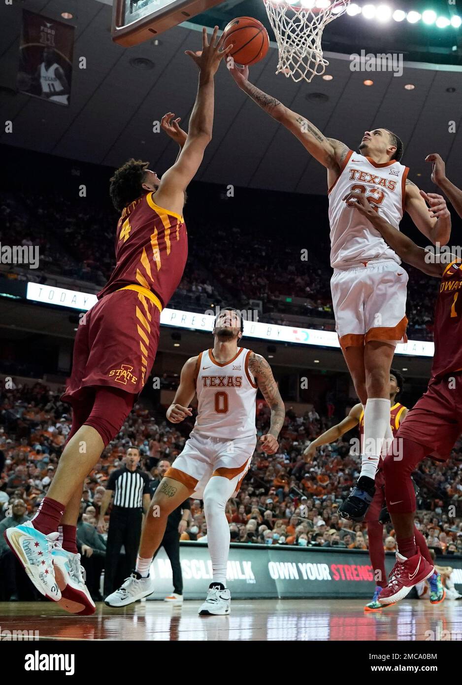 Texas forward Christian Bishop (32) drives to the basket against Iowa ...
