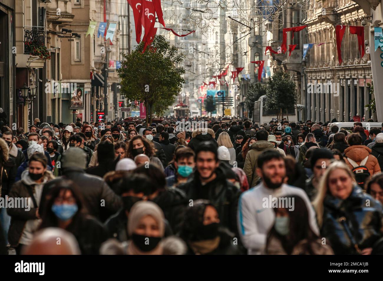 People walk in crowded Istiklal Street Istanbul, Saturday, Feb. 5, 2022 ...