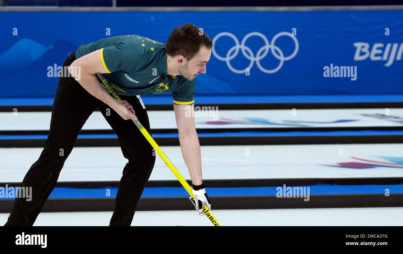 Australia's Dean Hewitt, sweeps the ice, during the mixed doubles match ...