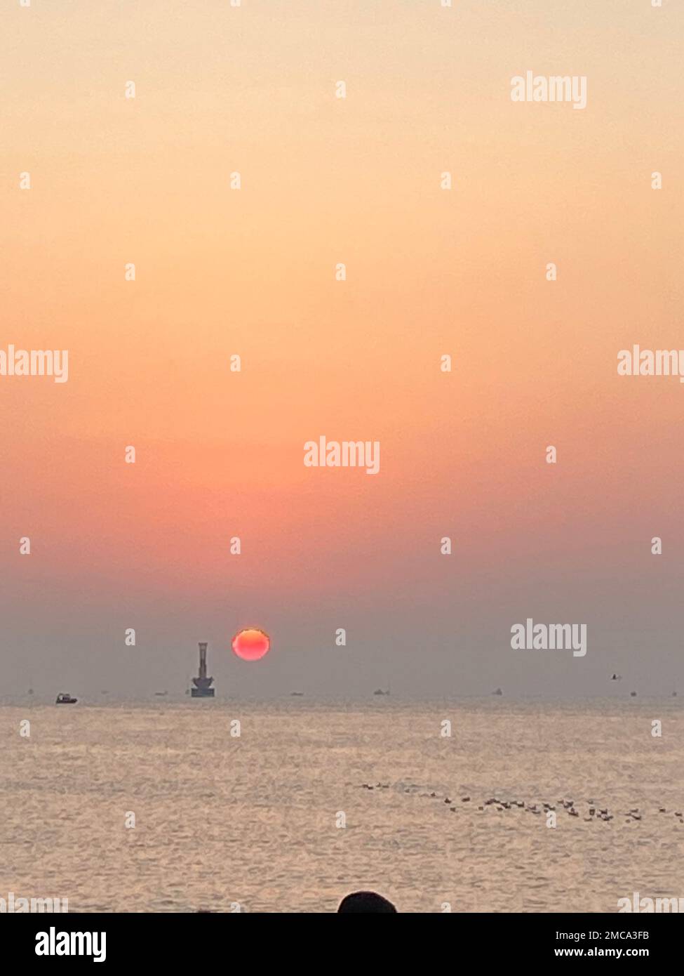 A view of the sunset over the sea Stock Photo - Alamy