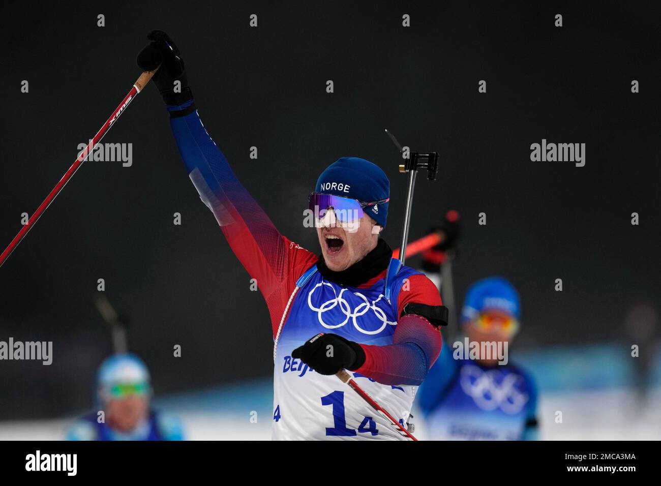 Johannes Thingnes Boe of Norway raises his arms after crossing the ...