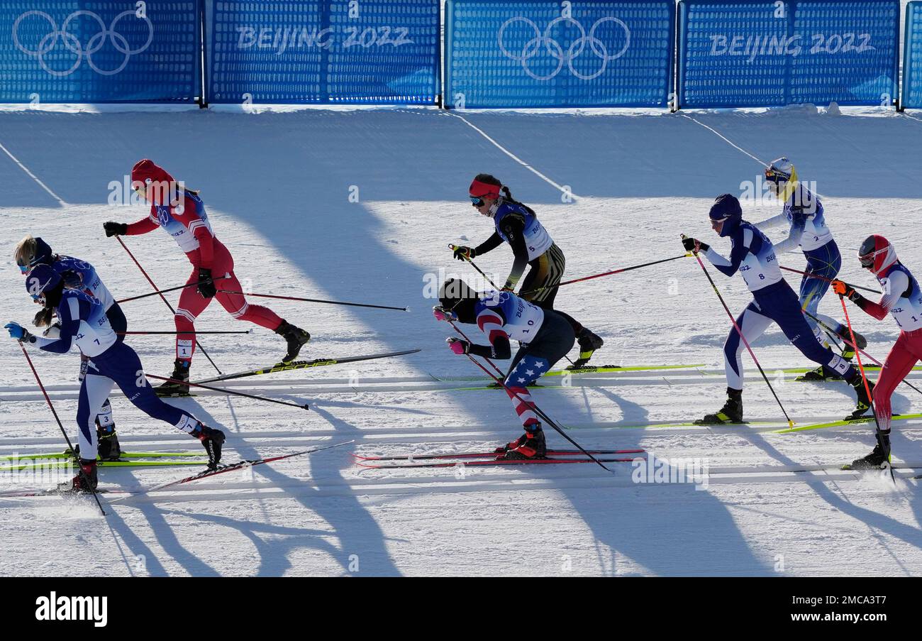 Skiers compete during the women's 7.5km + 7.5km skiathlon cross-country ...