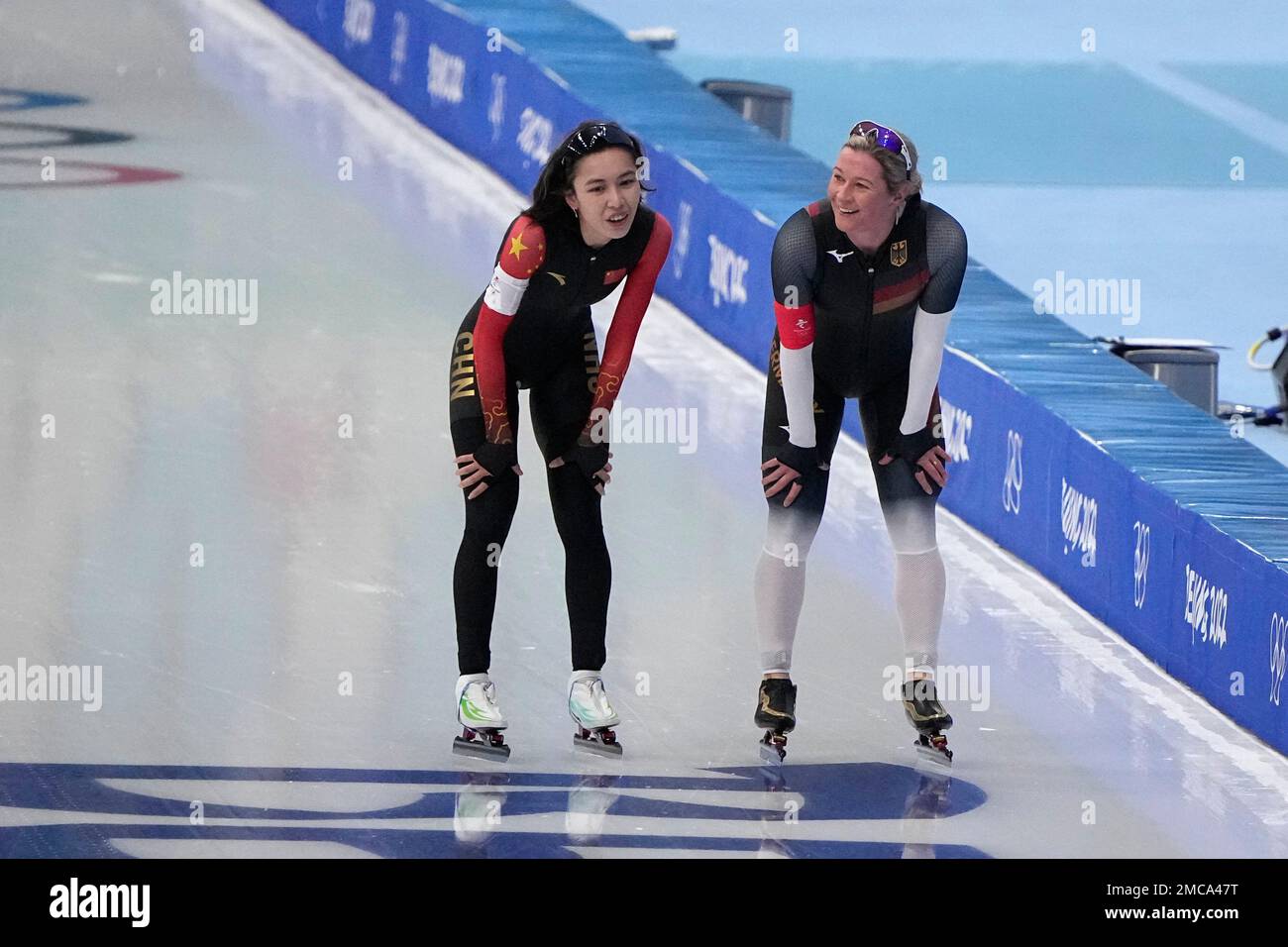 Ahenaer Adake of China, left, and Claudia Pechstein of Germany, greet ...