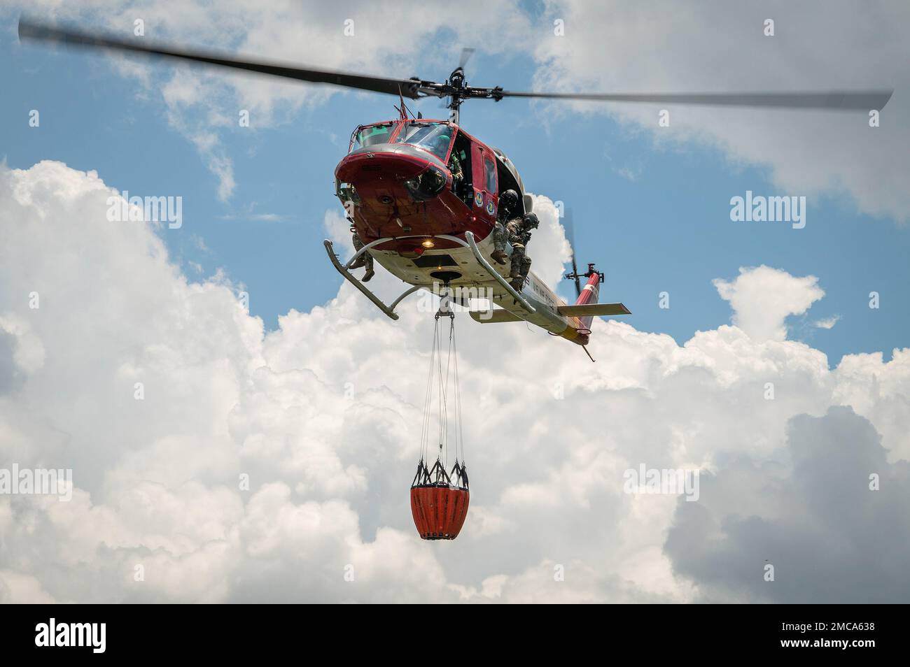 A 413th Flight Test Squadron UH-1 Huey approaches Anderson Pond to pick ...
