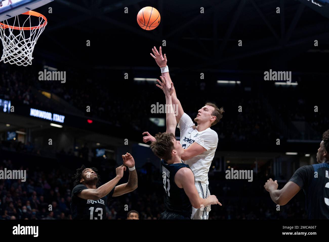 Xavier forward Jack Nunge, center right shoots over Butler's Simas ...