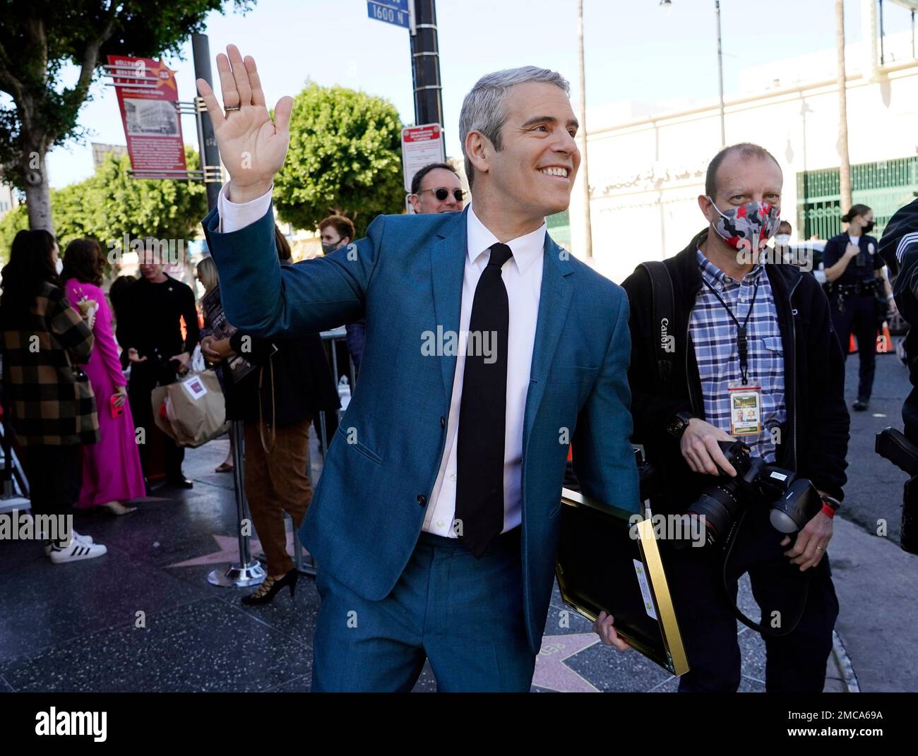 Talk show host Andy Cohen waves to the crowd following a ceremony to ...