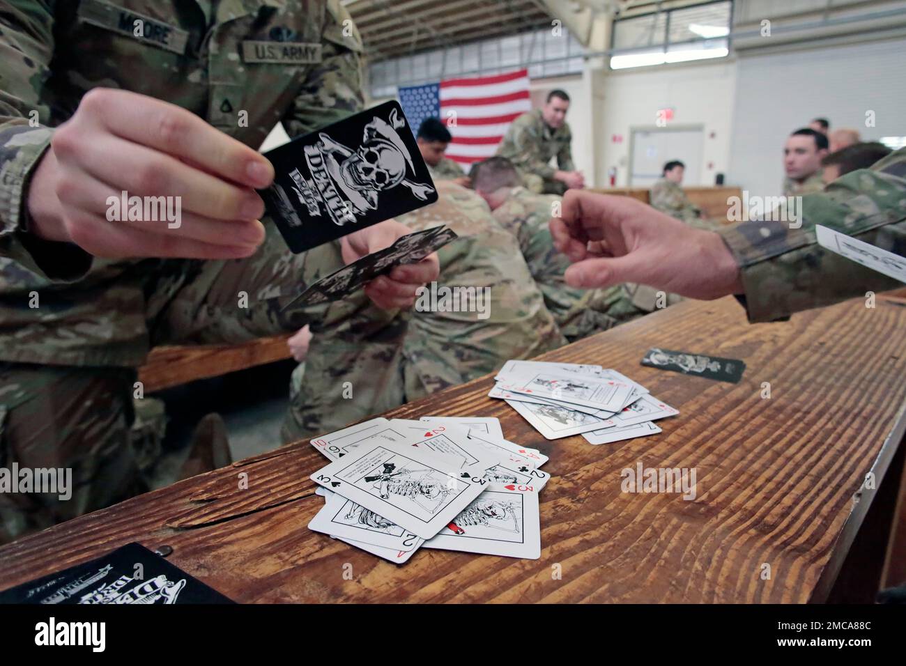 U.S. Army soldiers from the 18th Airborne Division play cards as they ...