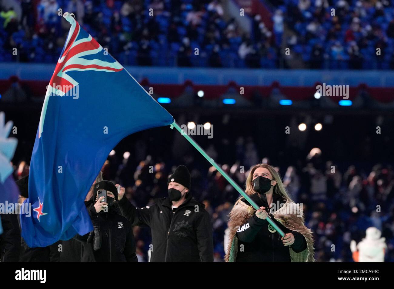 Alice Robinson, of New Zealand, carries her national flag during the ...