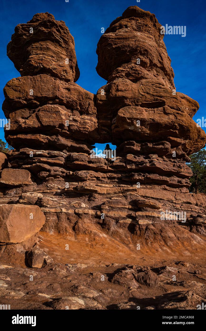 Two red rock sandstone pinnacles with a natural window eroded into ...
