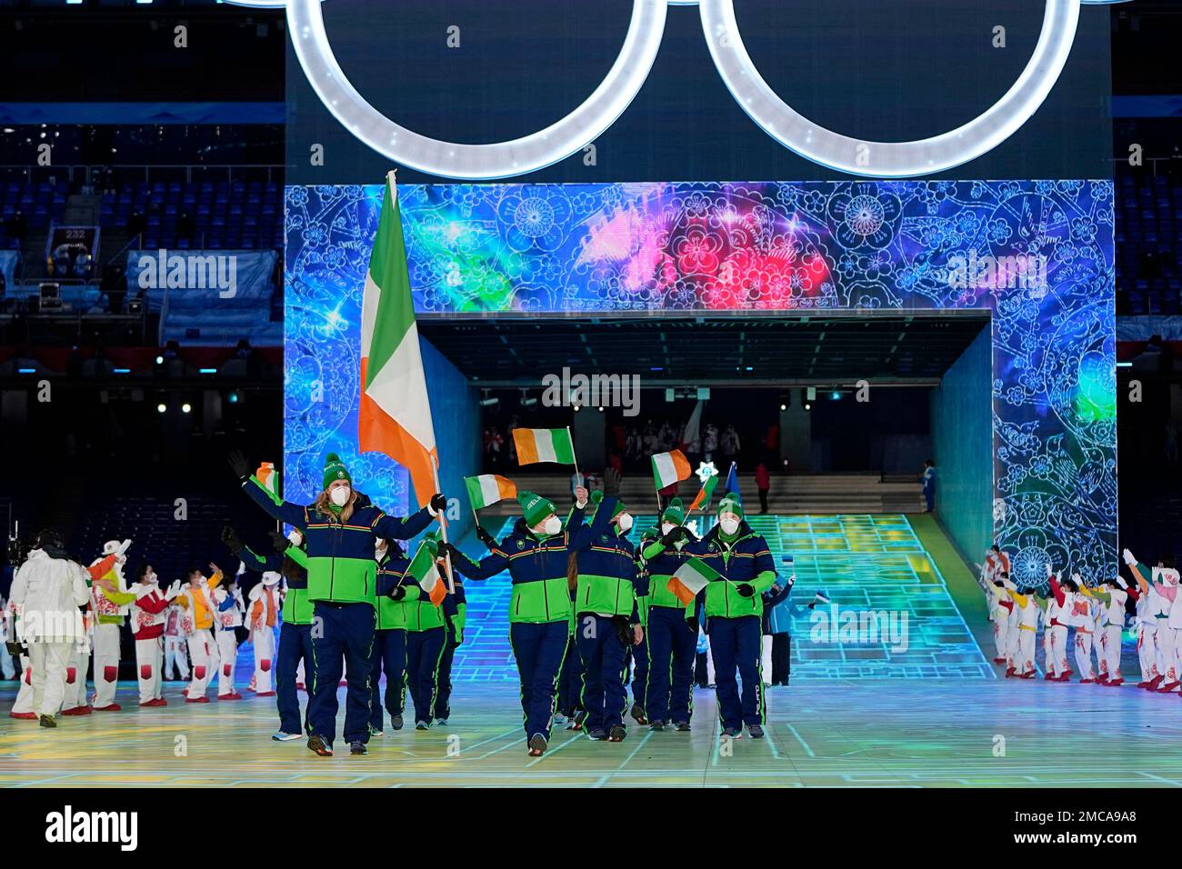Elsa Desmond and Brendan Newby, of Ireland, carry their national flag ...
