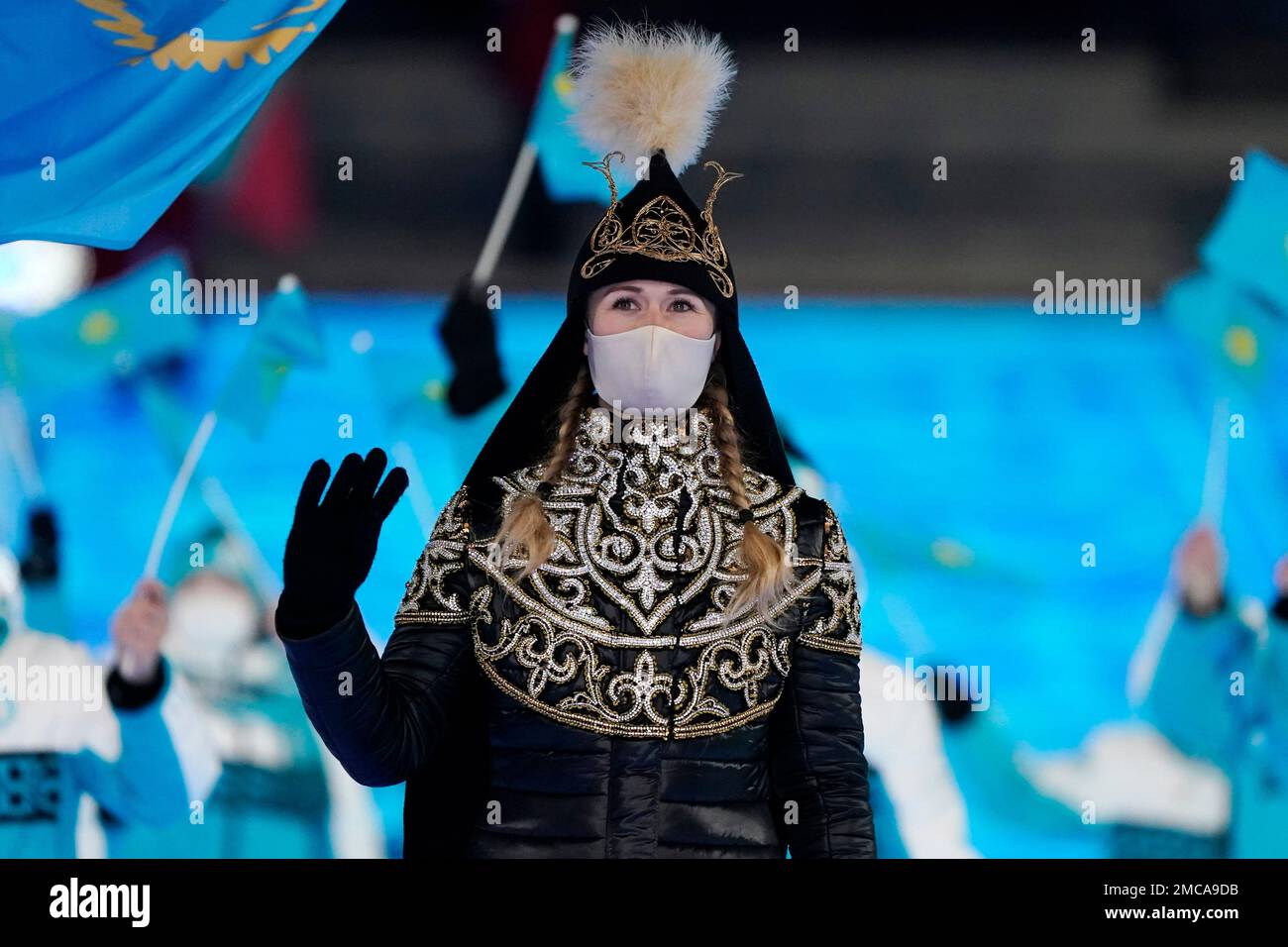 Yekaterina Aidova, of Kazakhstan, waves as she walks into the stadium ...
