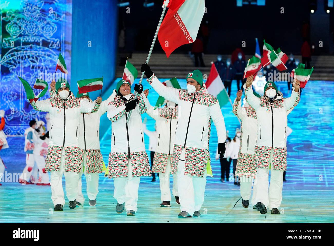 Atefeh Ahmadi and Seyed Sattar Seyd, of Iran, carries his national flag ...
