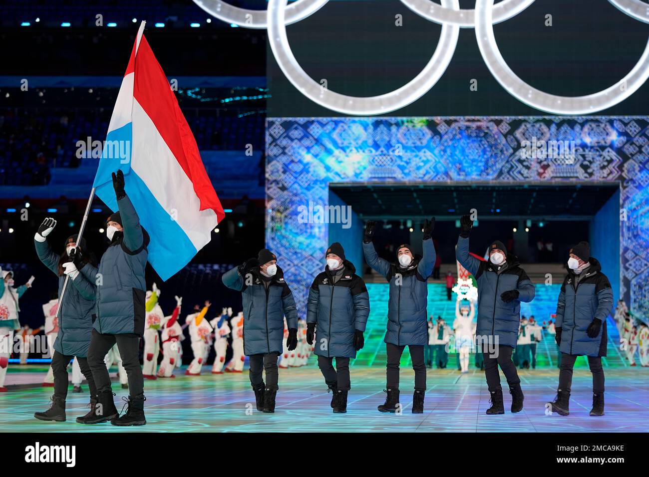 Matthieu Osch and Gwyneth Ten Raa, of Luxembourg, carry their national ...