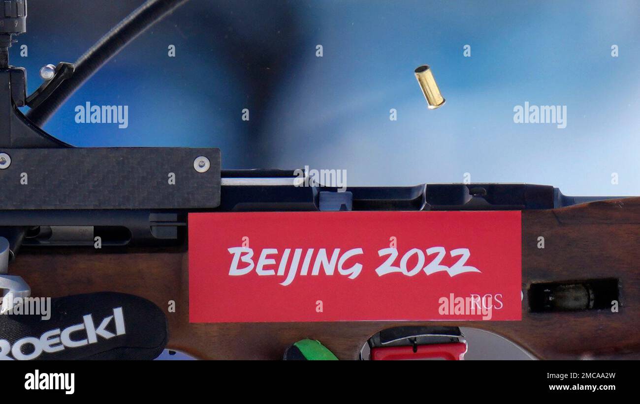 A shell casing is ejected during biathlon target shooting at the 2022 ...