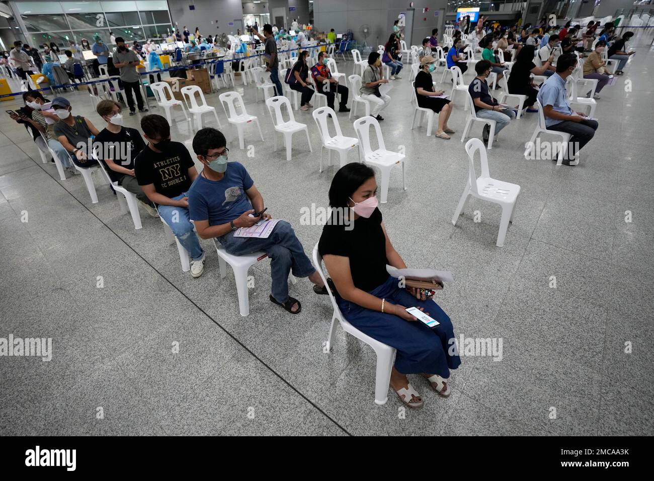 Local residents wait to receive shots of the Pfizer vaccine at the ...