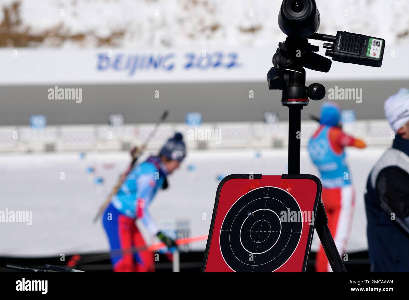 A biathletes skis by a target scope on the shooting range at the 2022 ...