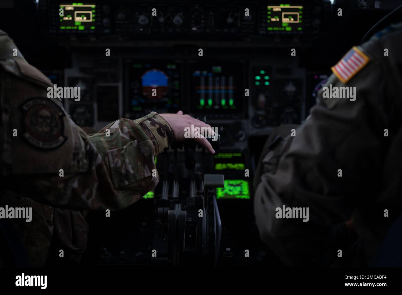 U.S. Air Force Capts. Michael Knowles, and Brandon Dumais, pilot a C-17 ...