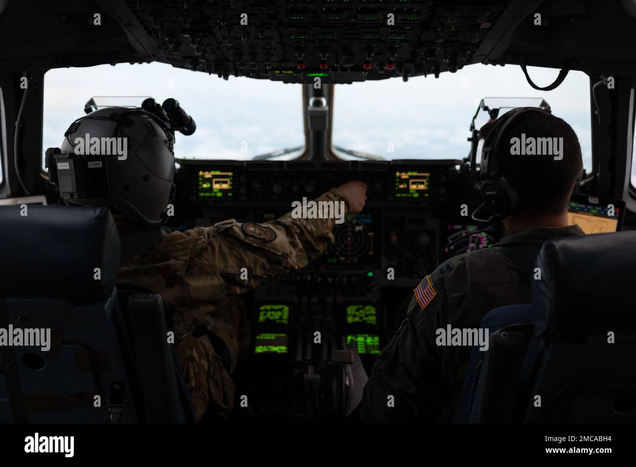 U.S. Air Force Capts. Michael Knowles, and Brandon Dumais, pilot a C-17 ...