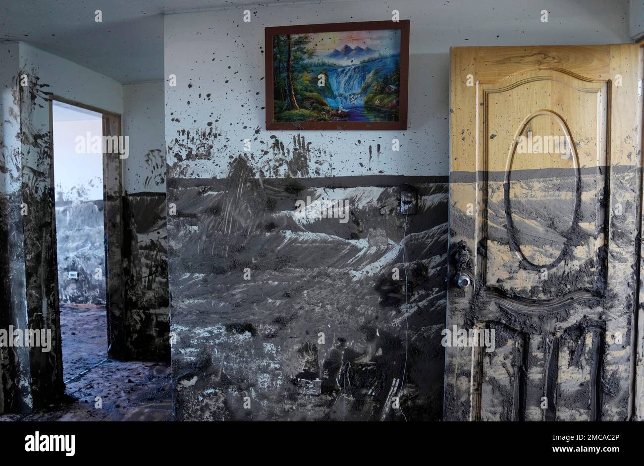 A line on a wall marks the mud level reached inside a home a day after ...