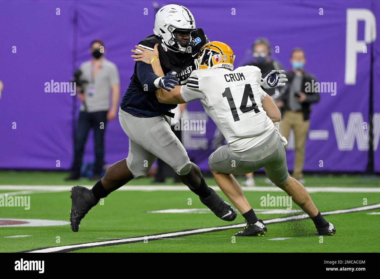 East quarterback Dustin Crum (14), of Kent State, is under pressure ...