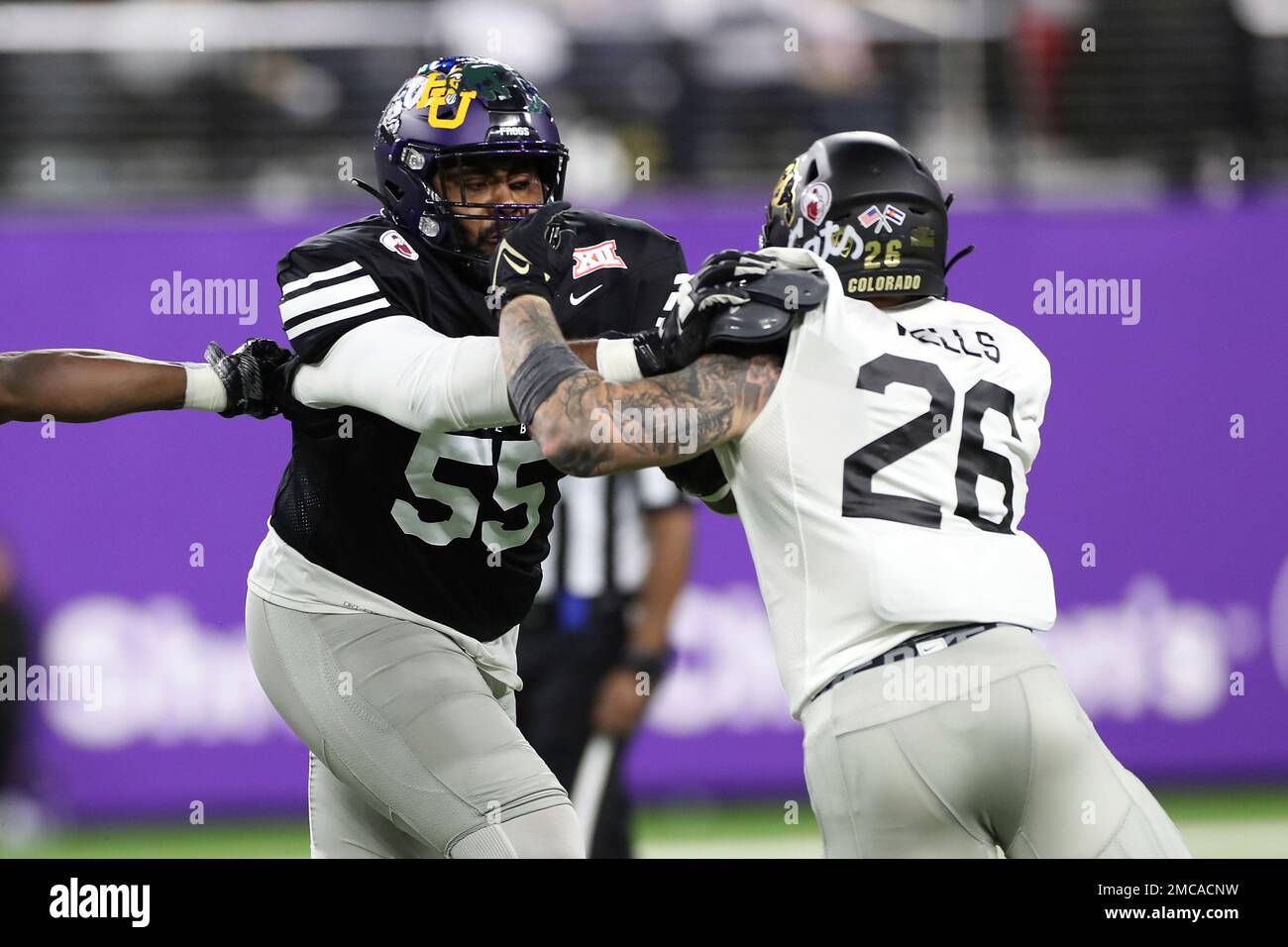 West offensive lineman Obinna Eze, of TCU, (55) blocks East linebacker Carson Wells, of Colorado ...