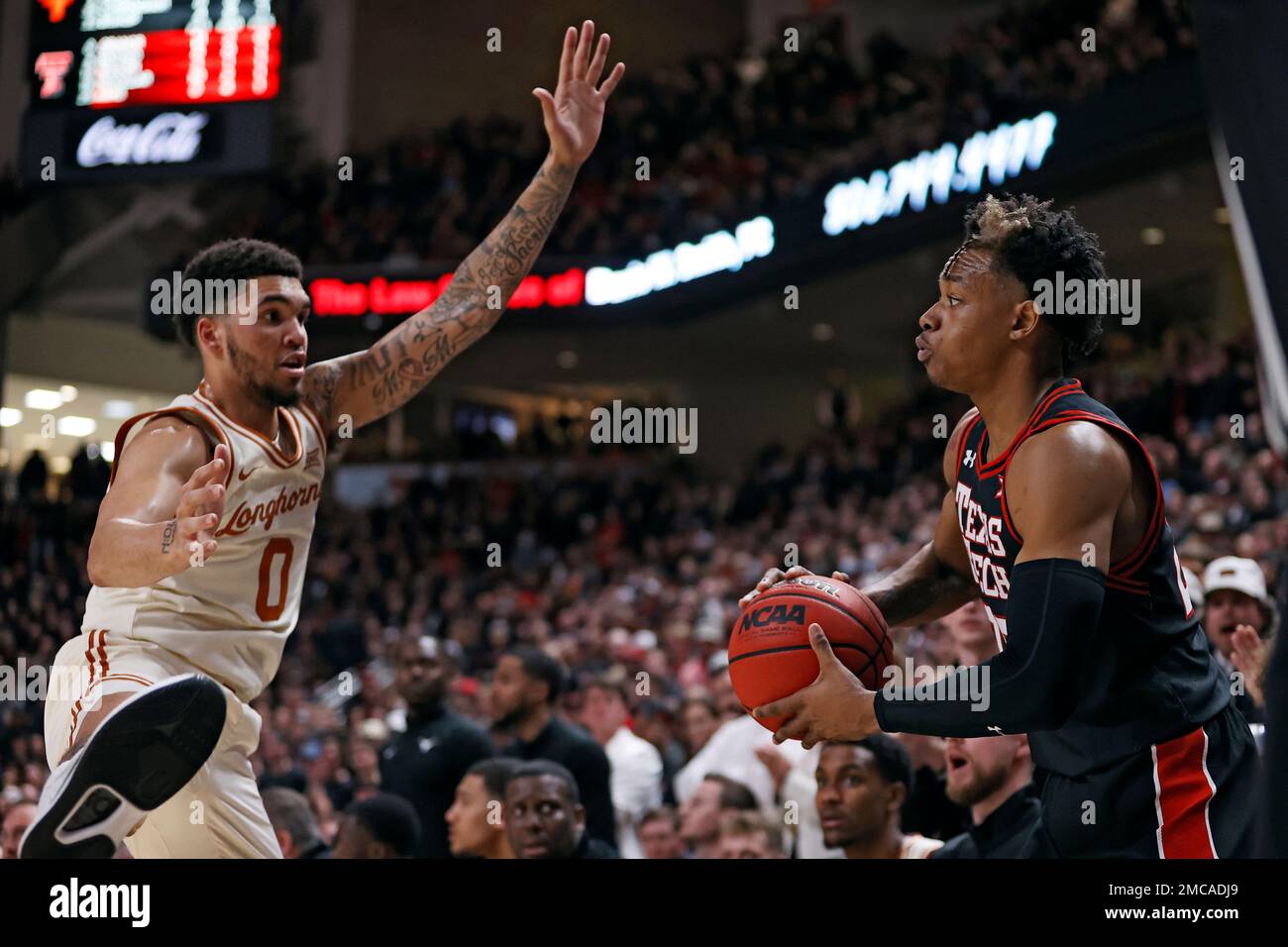 Texas Tech's Adonis Arms (25) looks to pass the ball around Texas ...