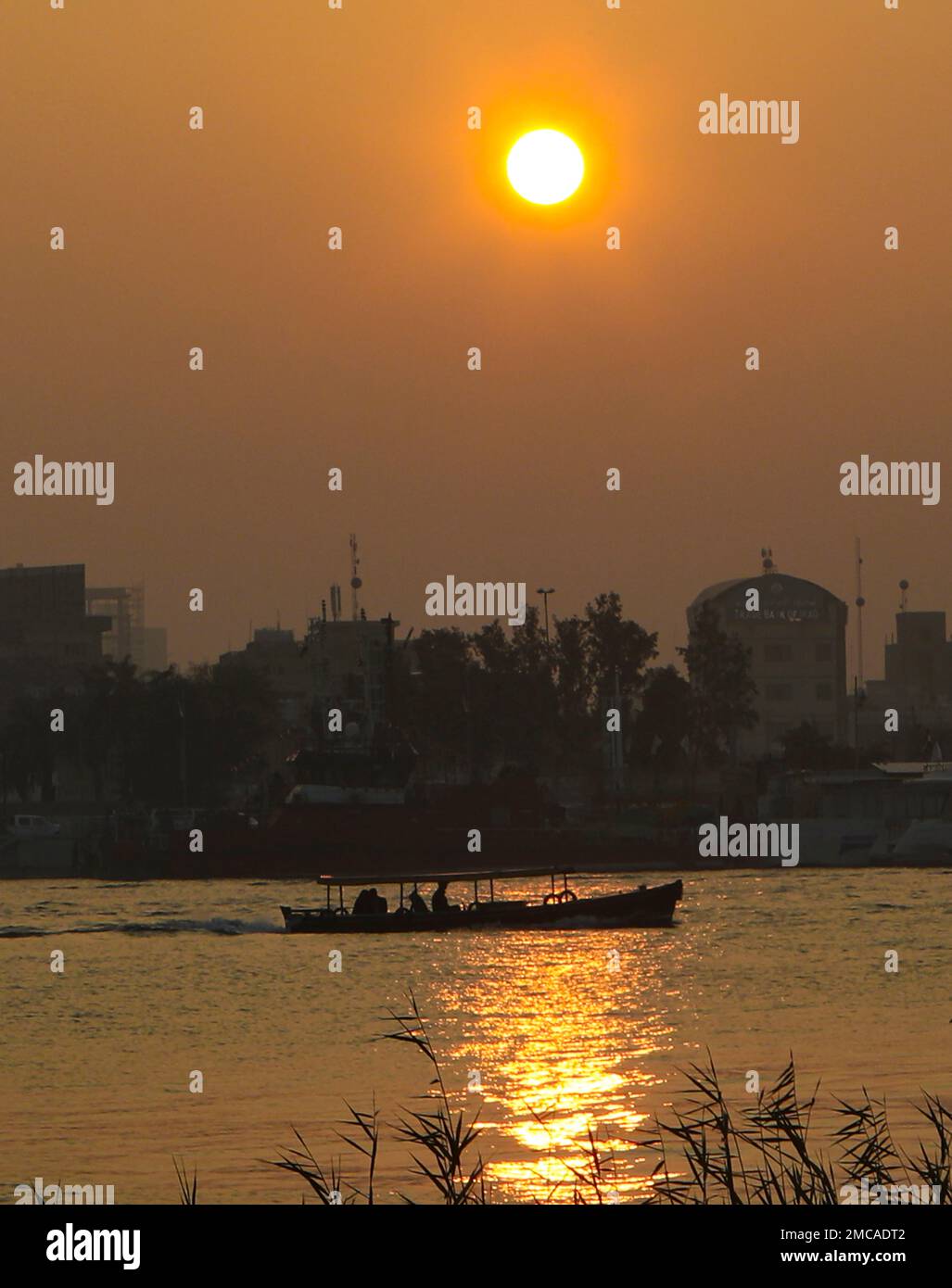 The sun sets over Shatt al-Arab waterway, in Basra, Iraq, Saturday, Jan ...