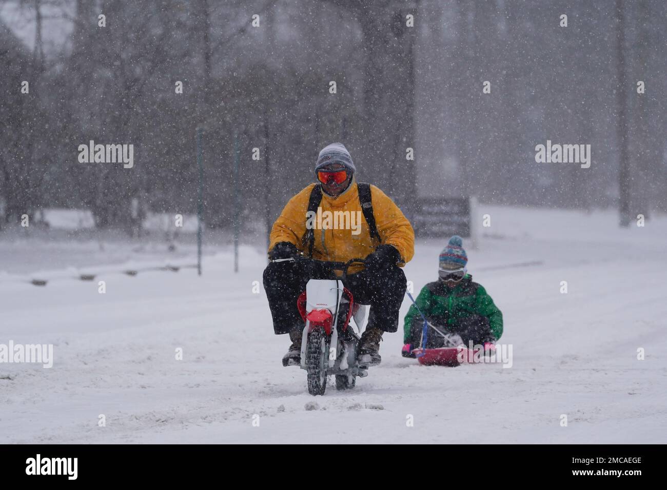 Adam Basch pulls Lim Walthall on his sled, Thursday, Feb. 3, 2022, in ...