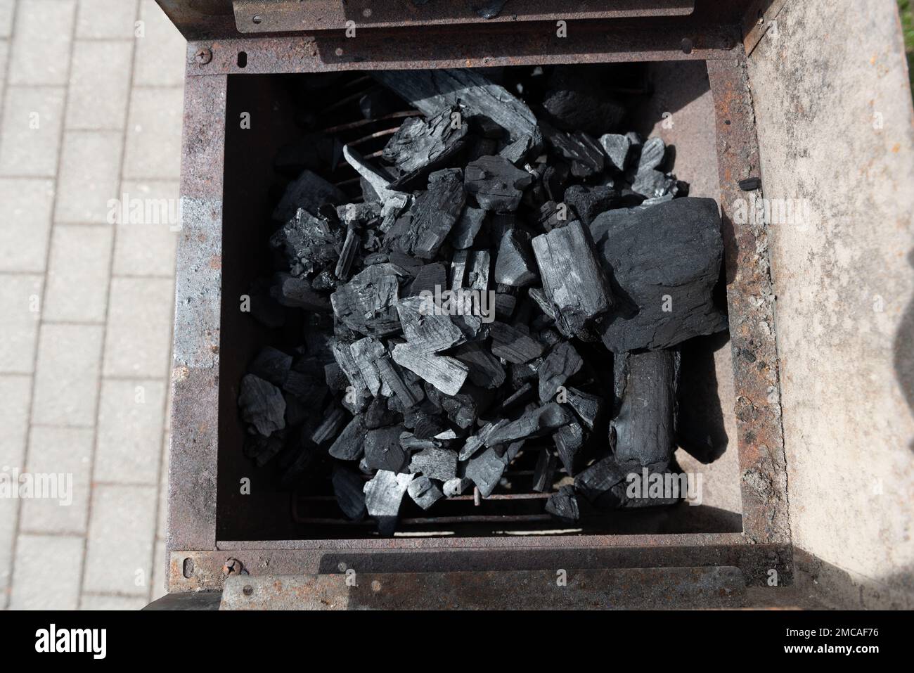 Coal on a barbeque ready to be lit Stock Photo - Alamy