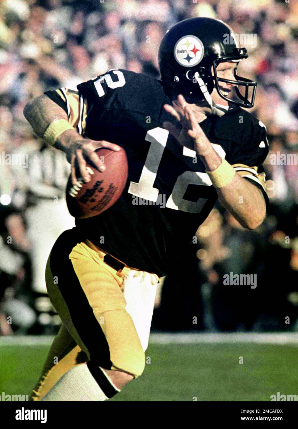 FILE - Pittsburgh Steelers quarterback Terry Bradshaw holds the ball ...