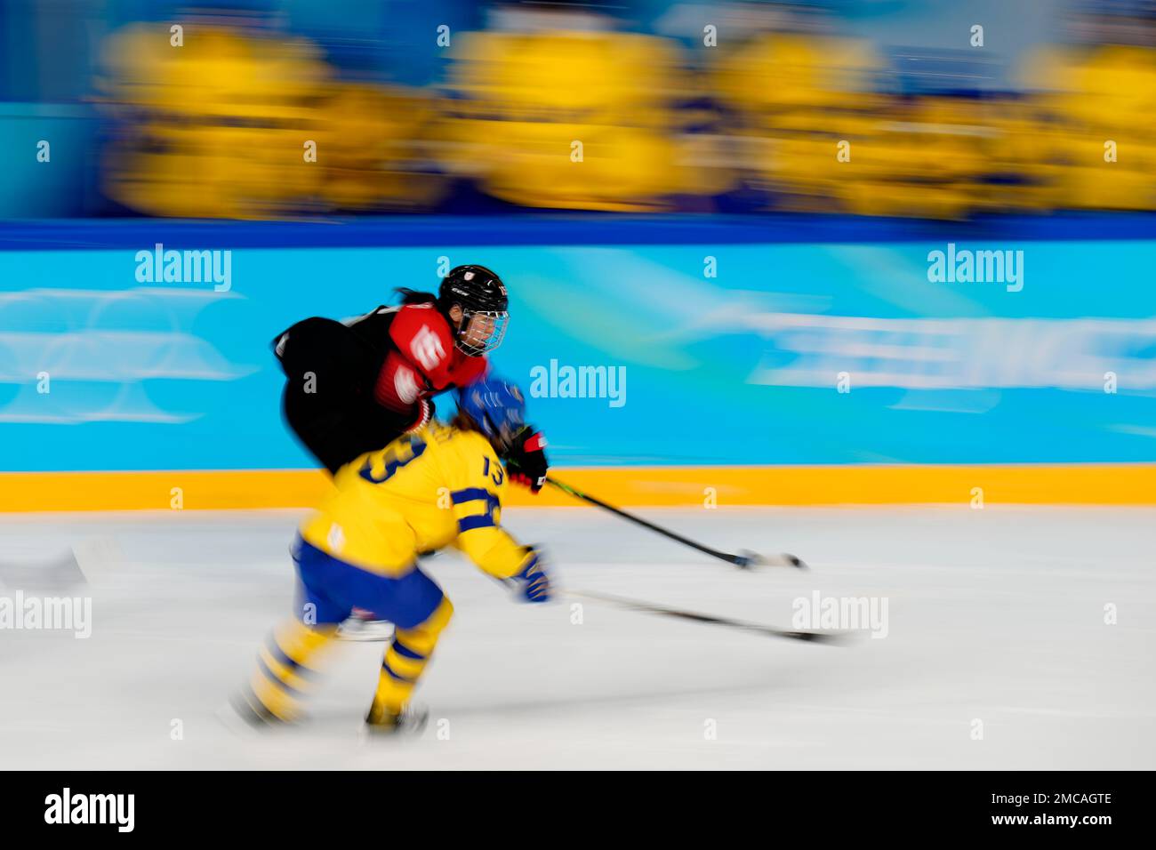 Japan's Rui Ukita (15) moves the puck against Sweden's Emma Muren (13 ...