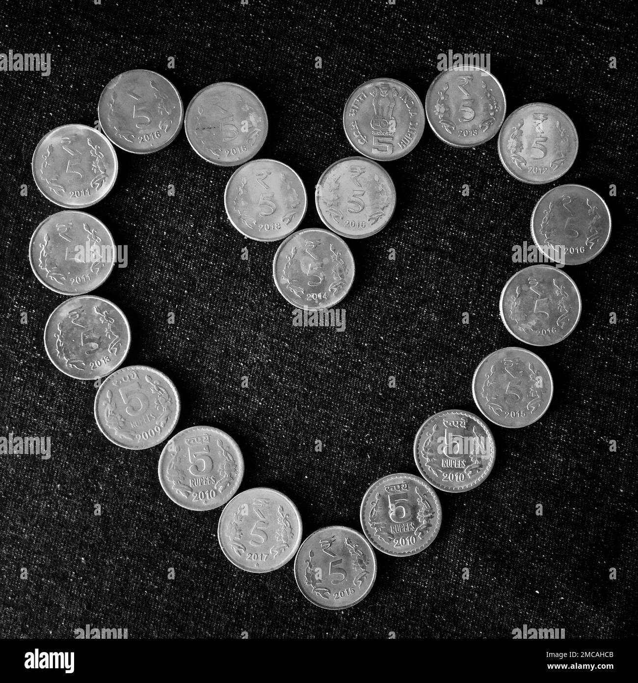 A monochrome and top shot of the heart shape made with coins Stock ...