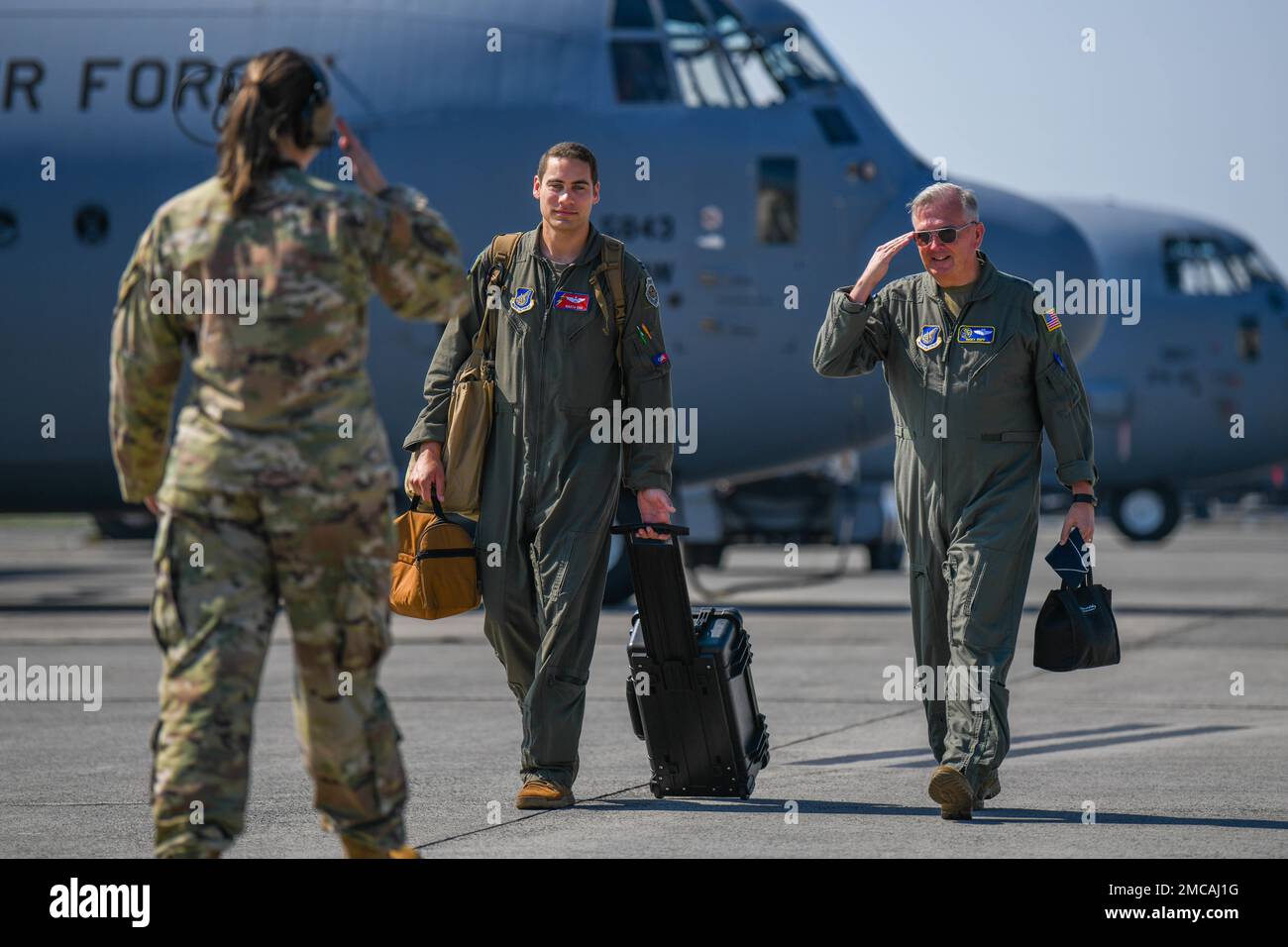 Lt. Gen. Ricky Rupp, 5th Air Force commander, right, salutes 1st Lt ...