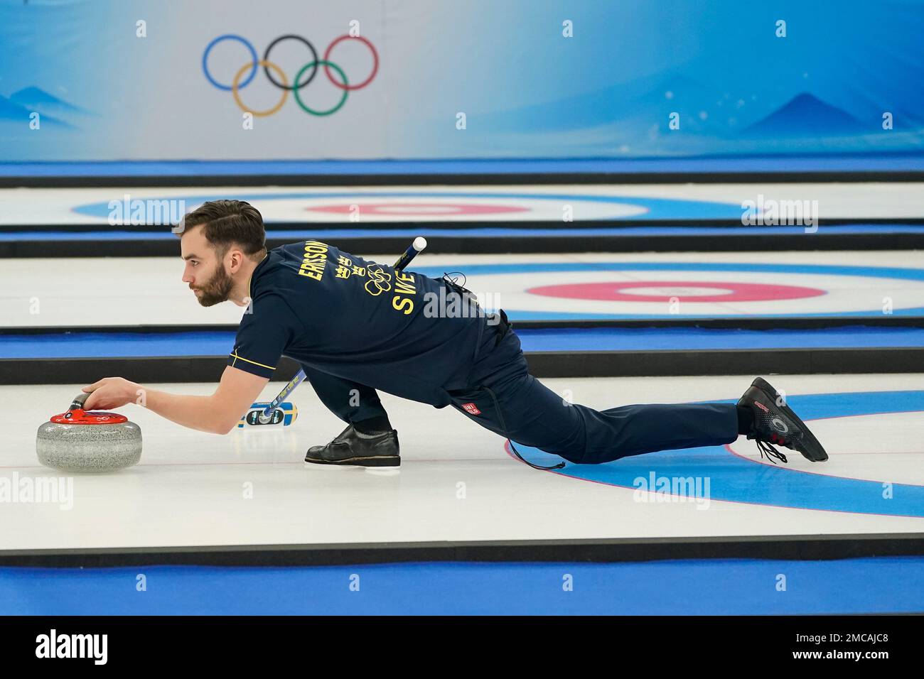 Oskar Eriksson, of Sweden, throws a rock during the mixed doubles ...