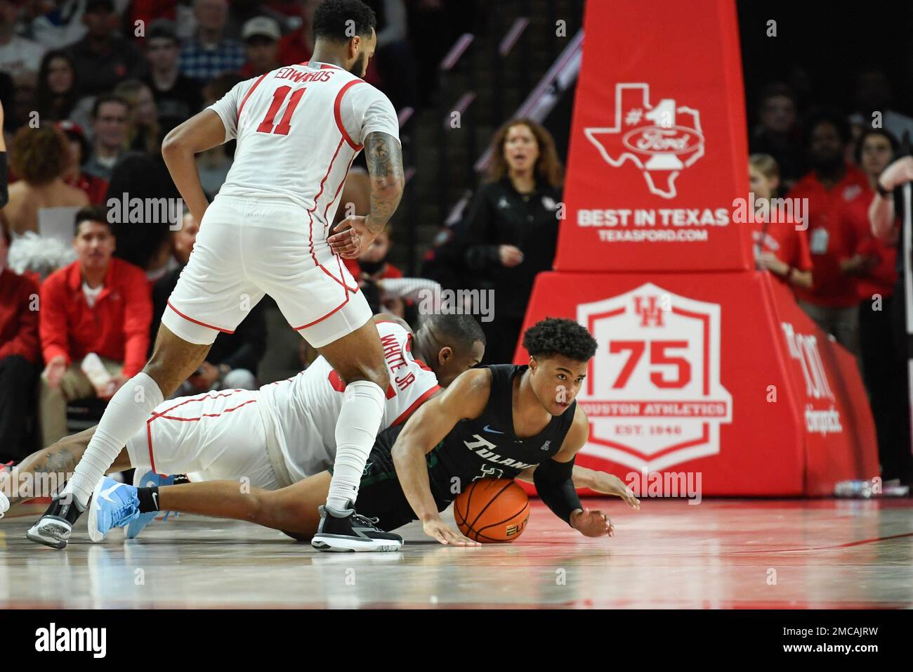 Tulane guard Jalen Cook and Houston forward Fabian White Jr. fall on a ...
