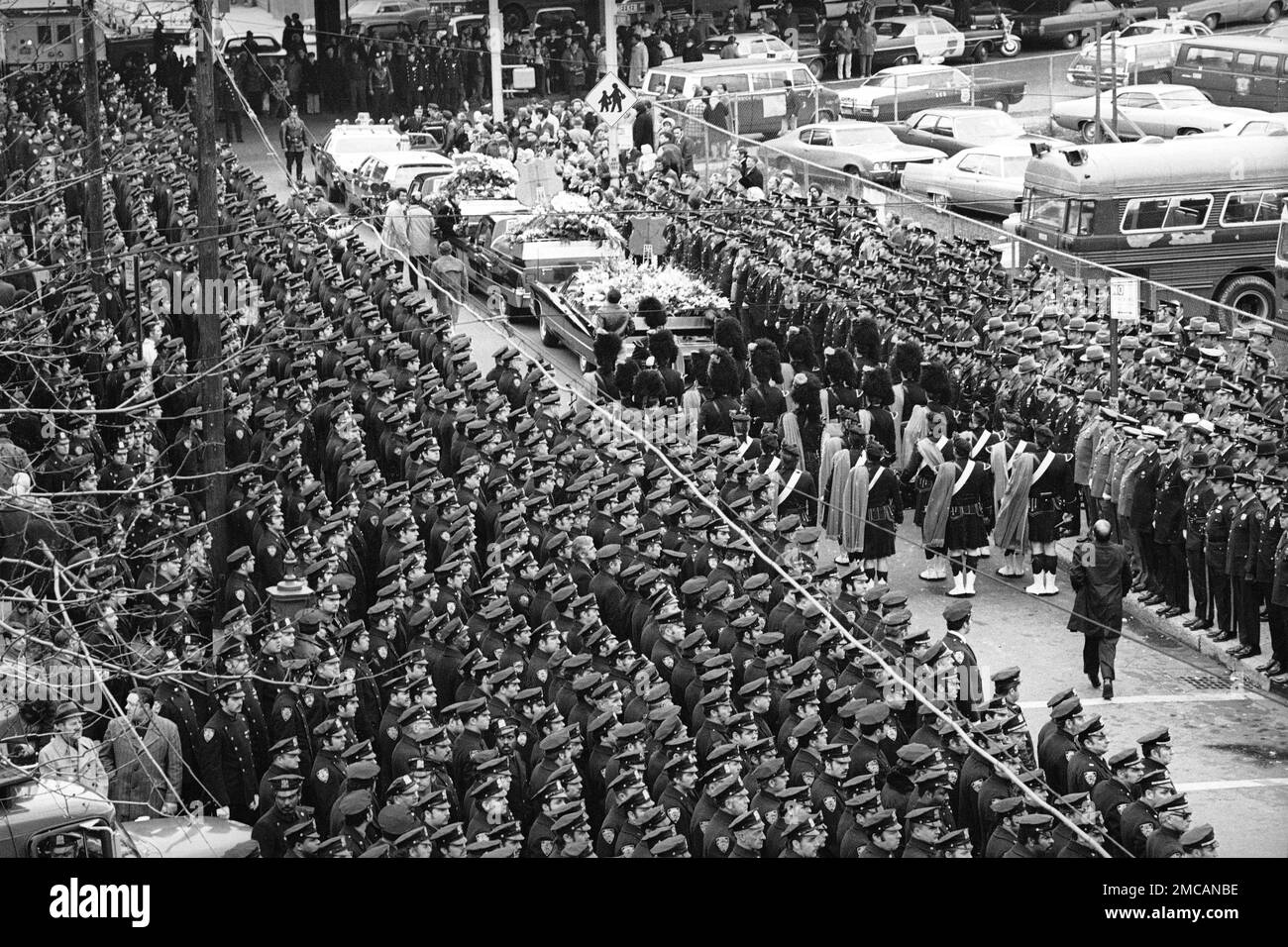 A hearse, third from front, carrying the body of slain police officer ...
