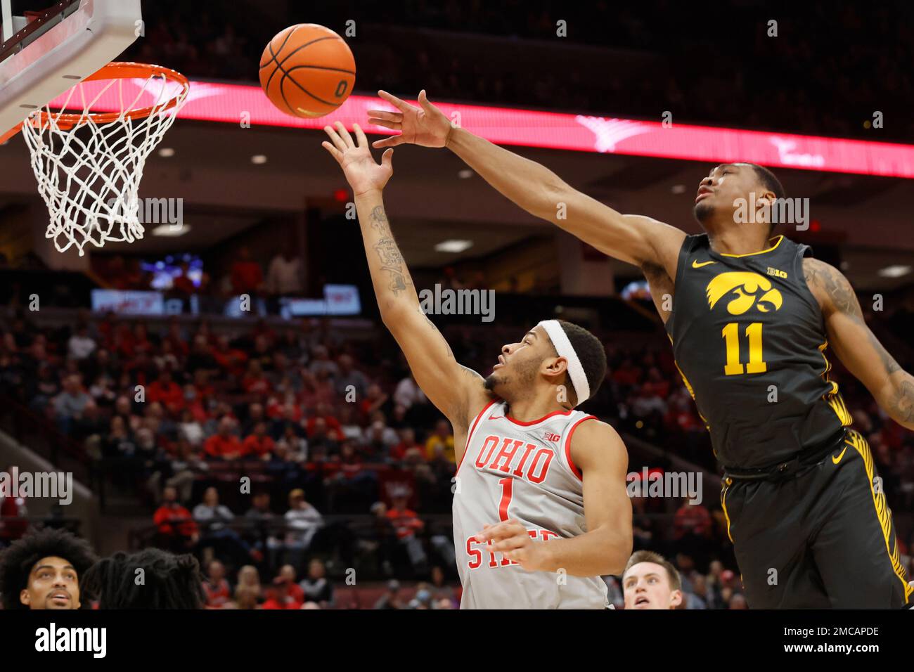 Ohio State's Roddy Gayle, left, shoots past Iowa's Tony Perkins during ...