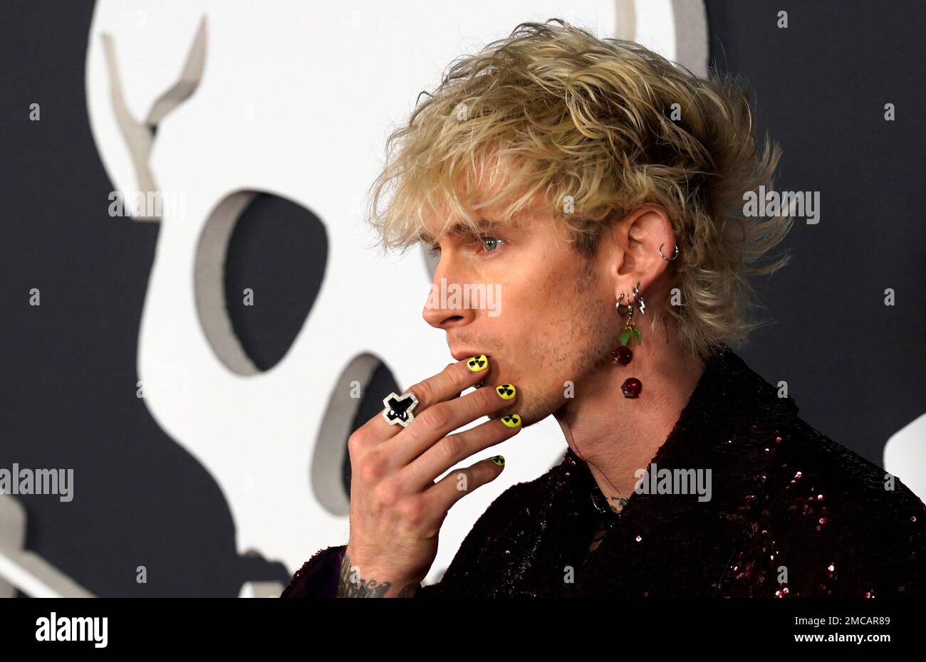 Machine Gun Kelly poses at the premiere of the film "Jackass Forever ...
