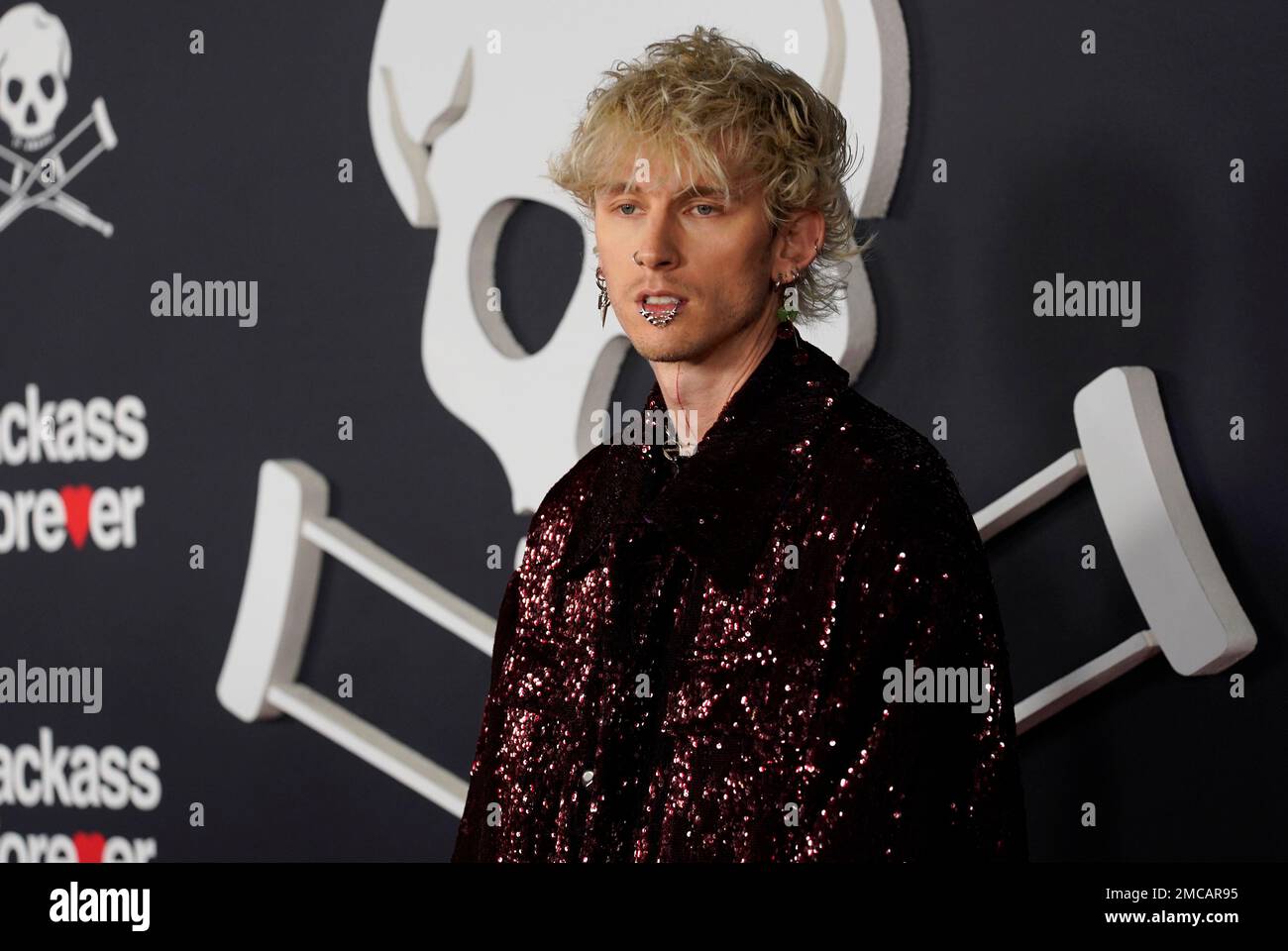 Machine Gun Kelly poses at the premiere of the film "Jackass Forever ...