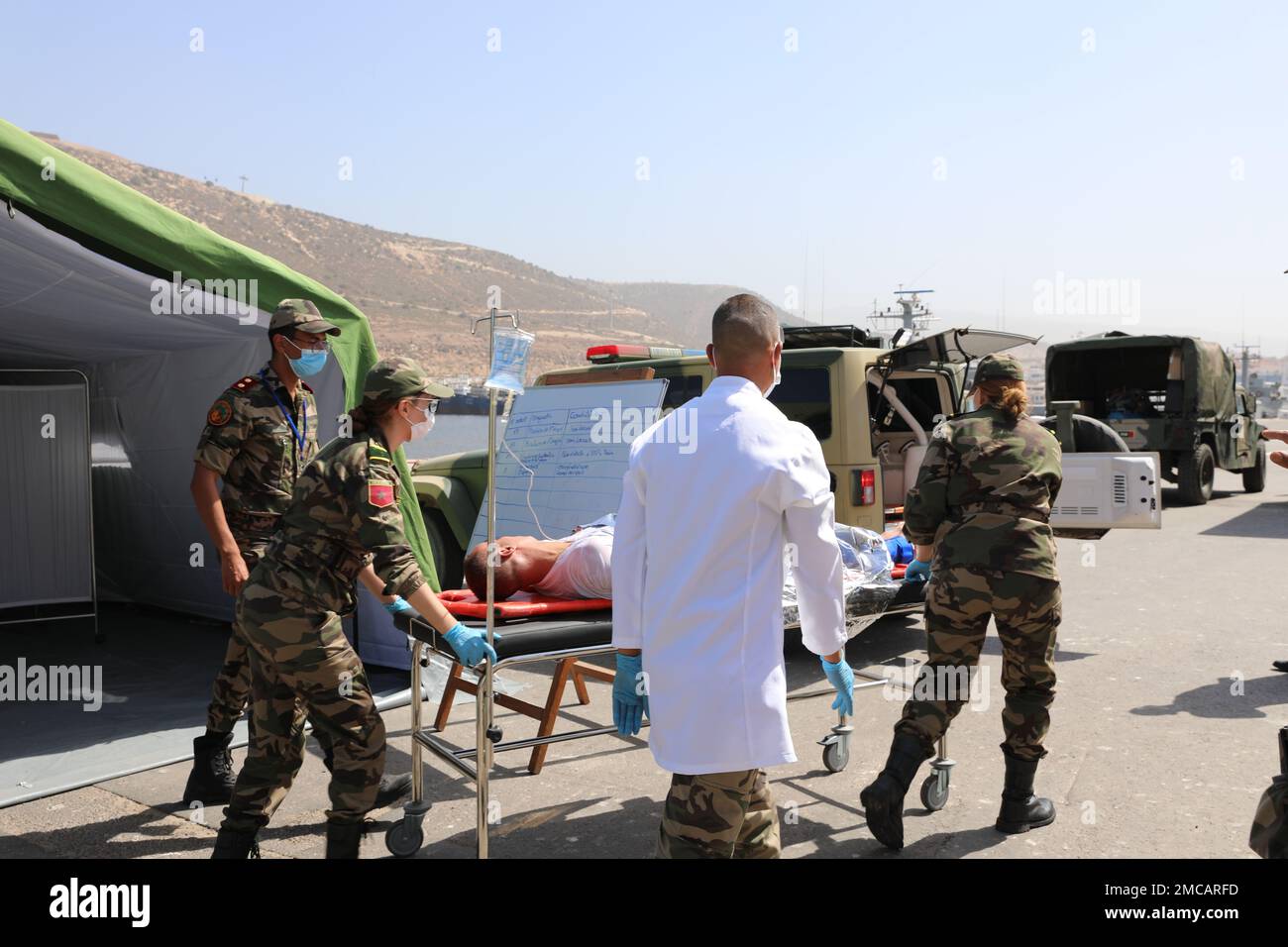 Moroccan Royal Army medical team moves a simulated patient for ...