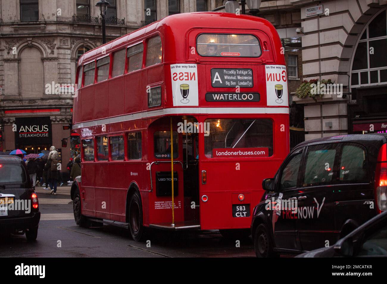 Traditional old red London Double Decker bus seen from the back. Sign ...