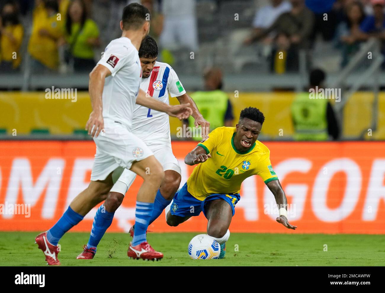 Brazil's Vini Jr, right, is fouled by Paraguay's Robert Rojas, center ...