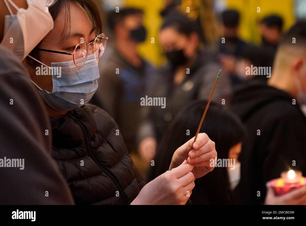 A worshipper reads her lottery poetry with Kau Chim sticks during the ...